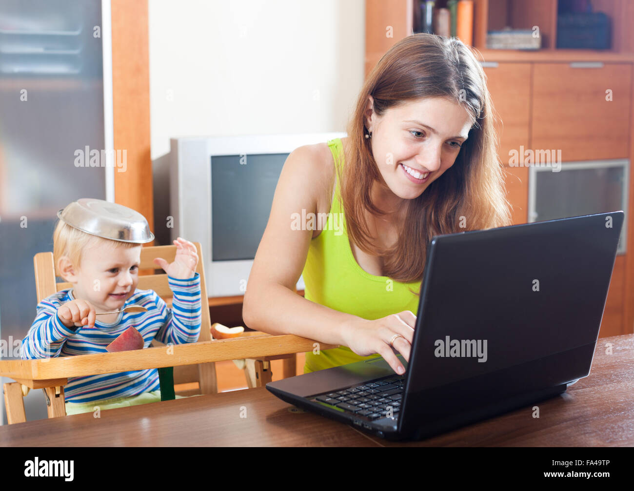 mother working at home with baby Stock Photo - Alamy