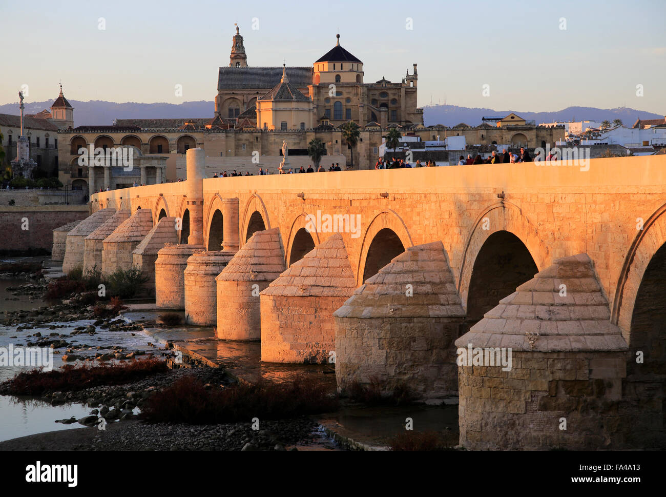 Roman bridge spanning river Rio Guadalquivir with Mezquita buildings ...
