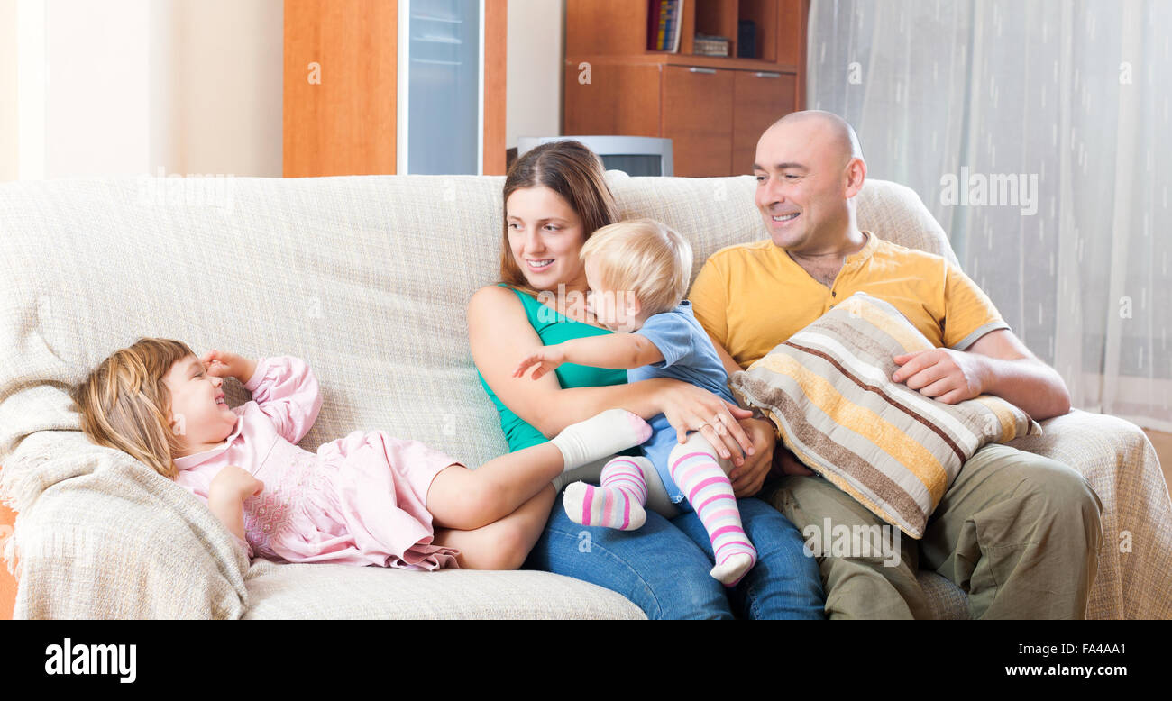 Parents with two children with two children at home interior Stock ...