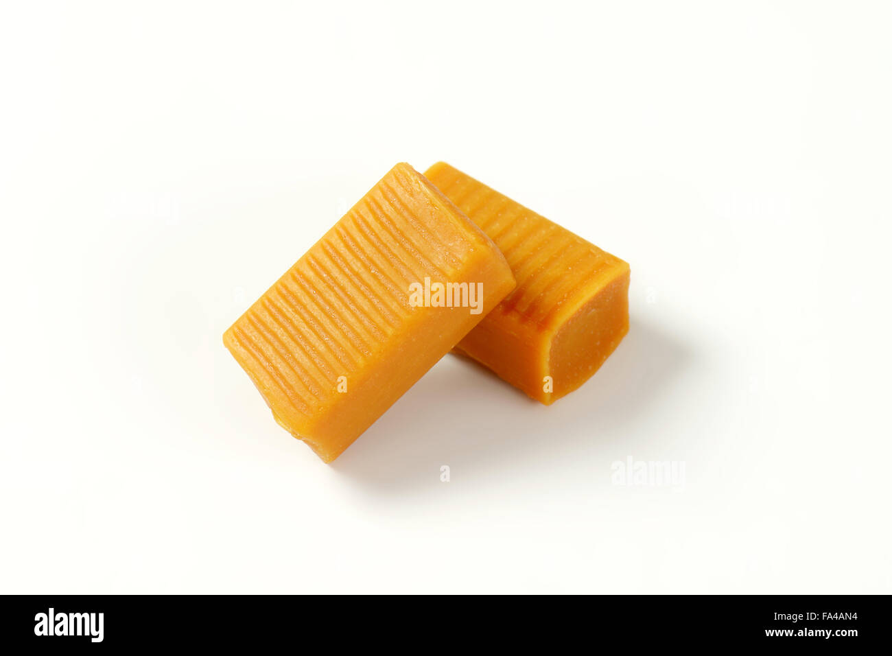 Chewy toffee candies on white background Stock Photo - Alamy