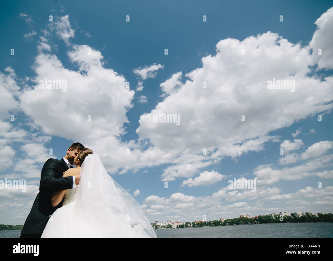 couple on blue sky background, water Stock Photo - Alamy
