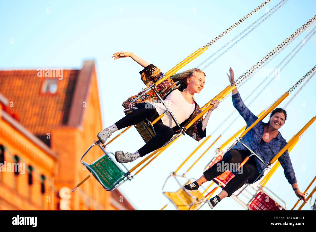 Young woman on fairground ride Stock Photo - Alamy