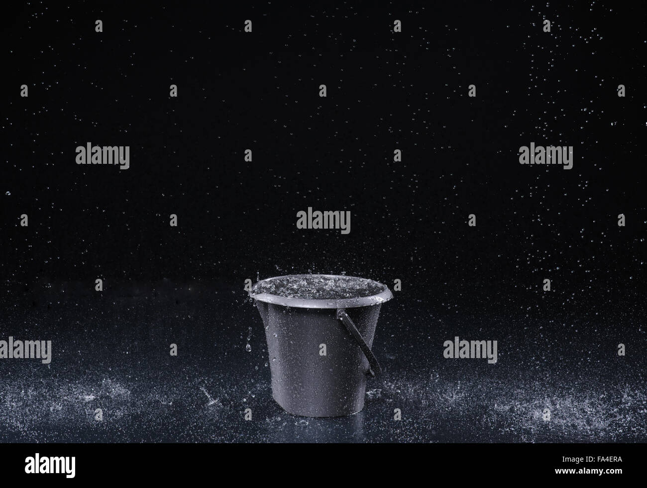 Bucket with water drops on dark background Stock Photo - Alamy
