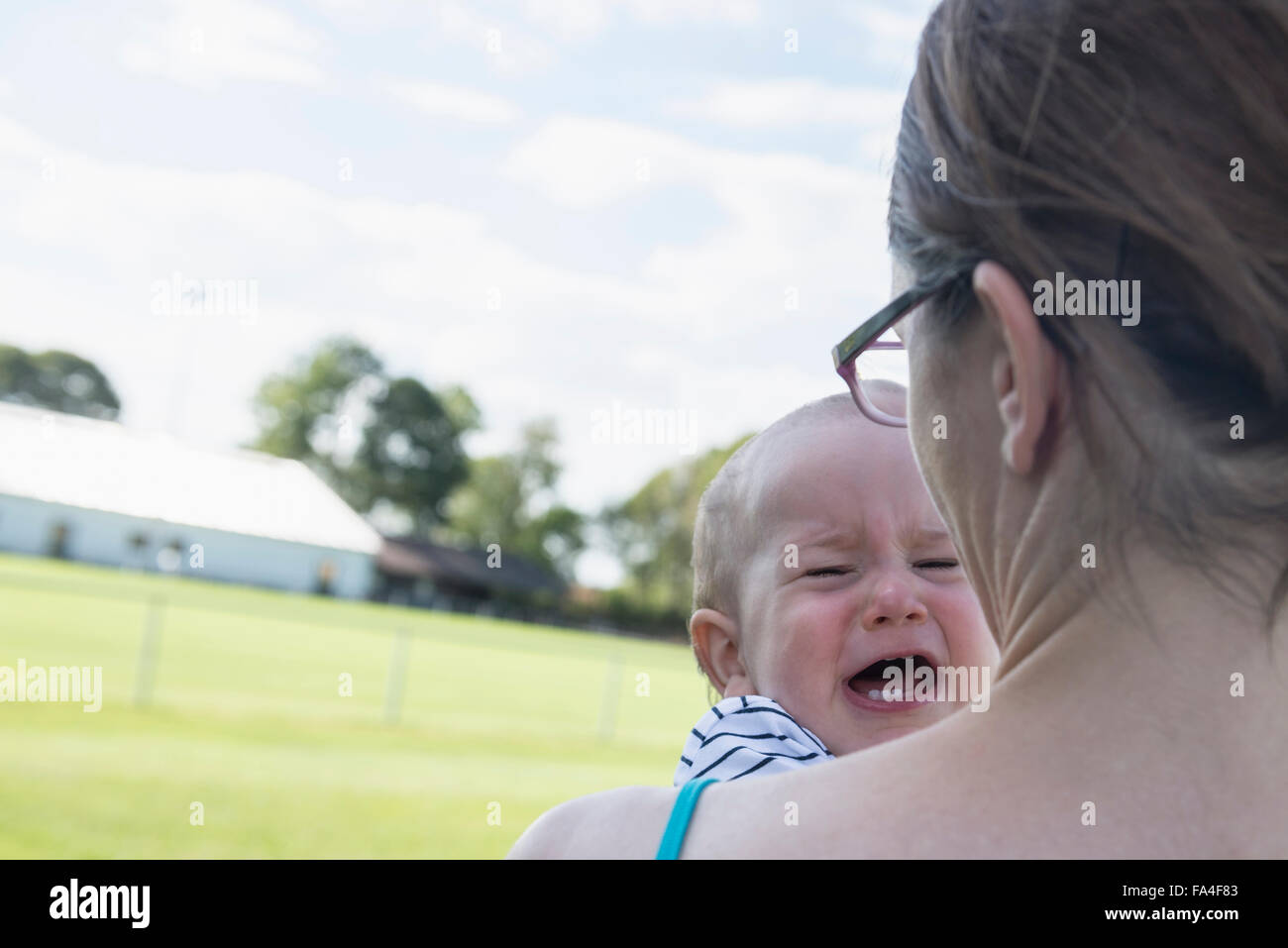 Baby boy crying in the arms of his mother, Munich, Bavaria, Germany ...