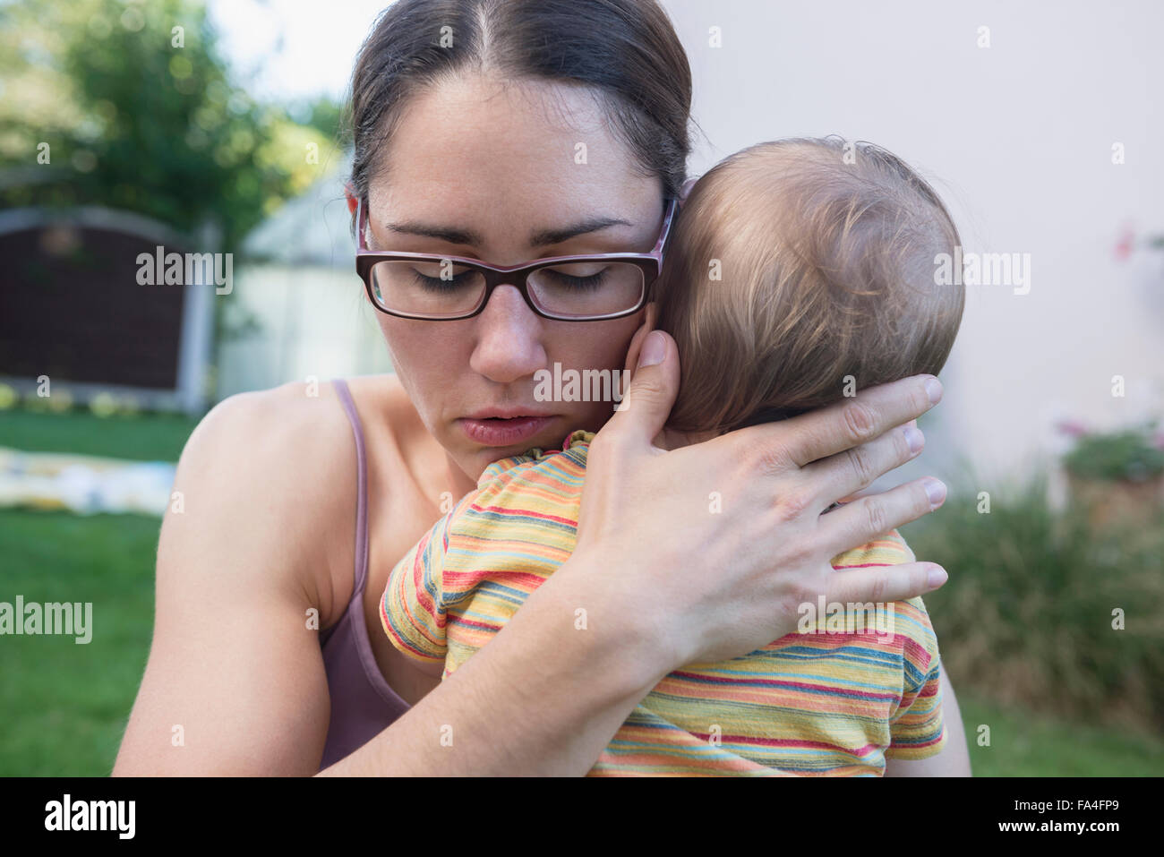 Mother comfort her baby son in a lawn, Munich, Bavaria, Germany Stock ...