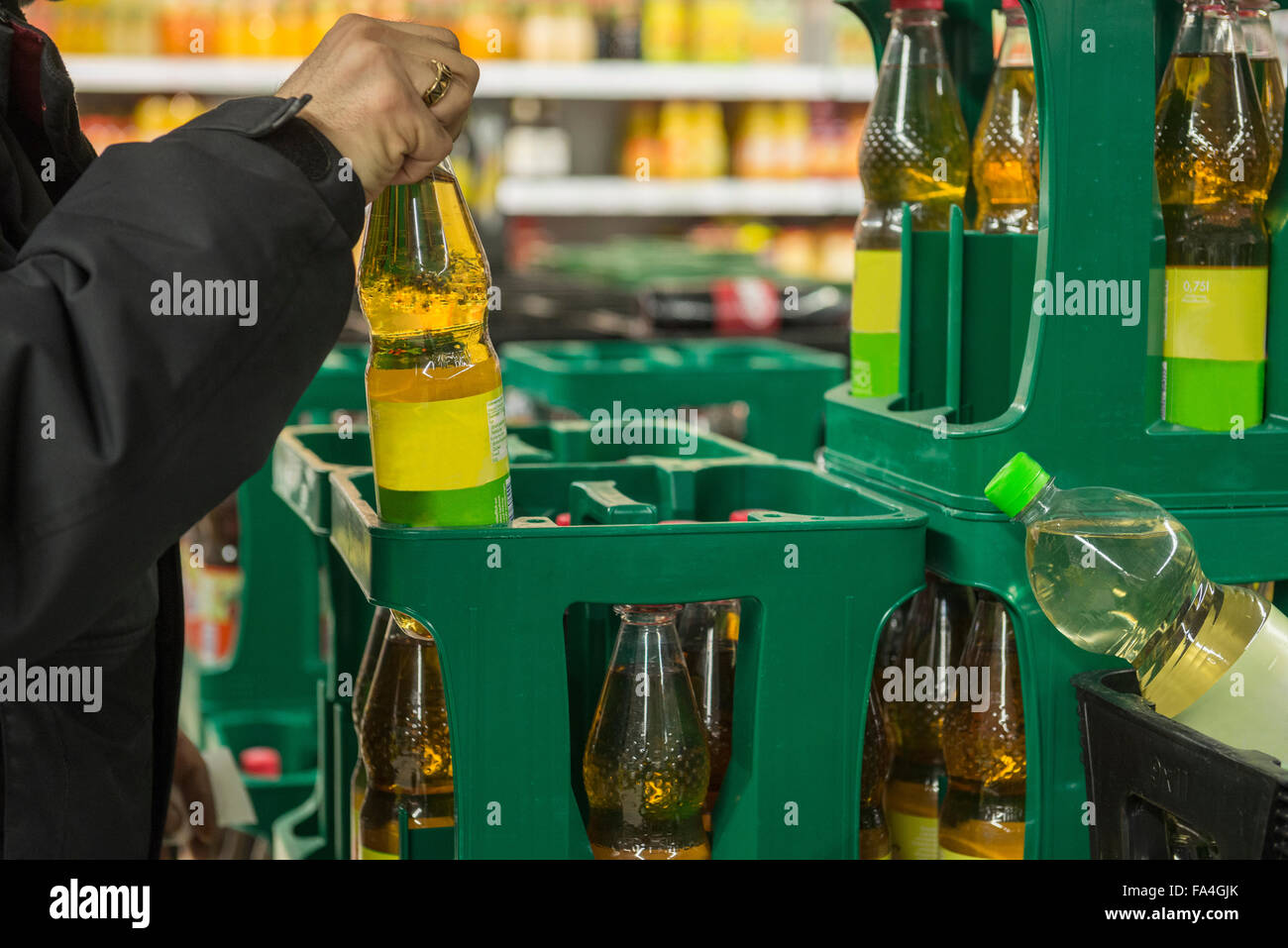 Customer picking a bottle of lemonade in supermarket, Munich, Bavaria ...