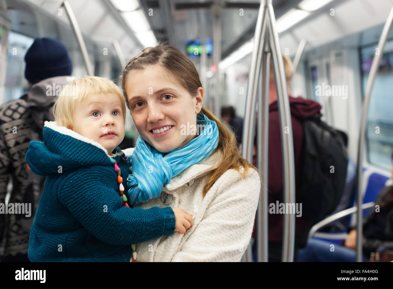mother with baby in subway train at metro Stock Photo - Alamy