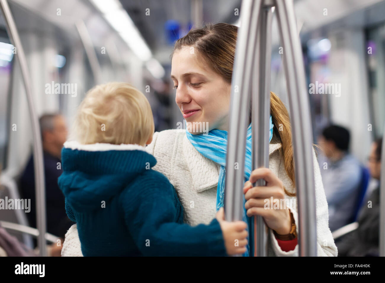 Photo of young mother with baby inside metro train Stock Photo - Alamy
