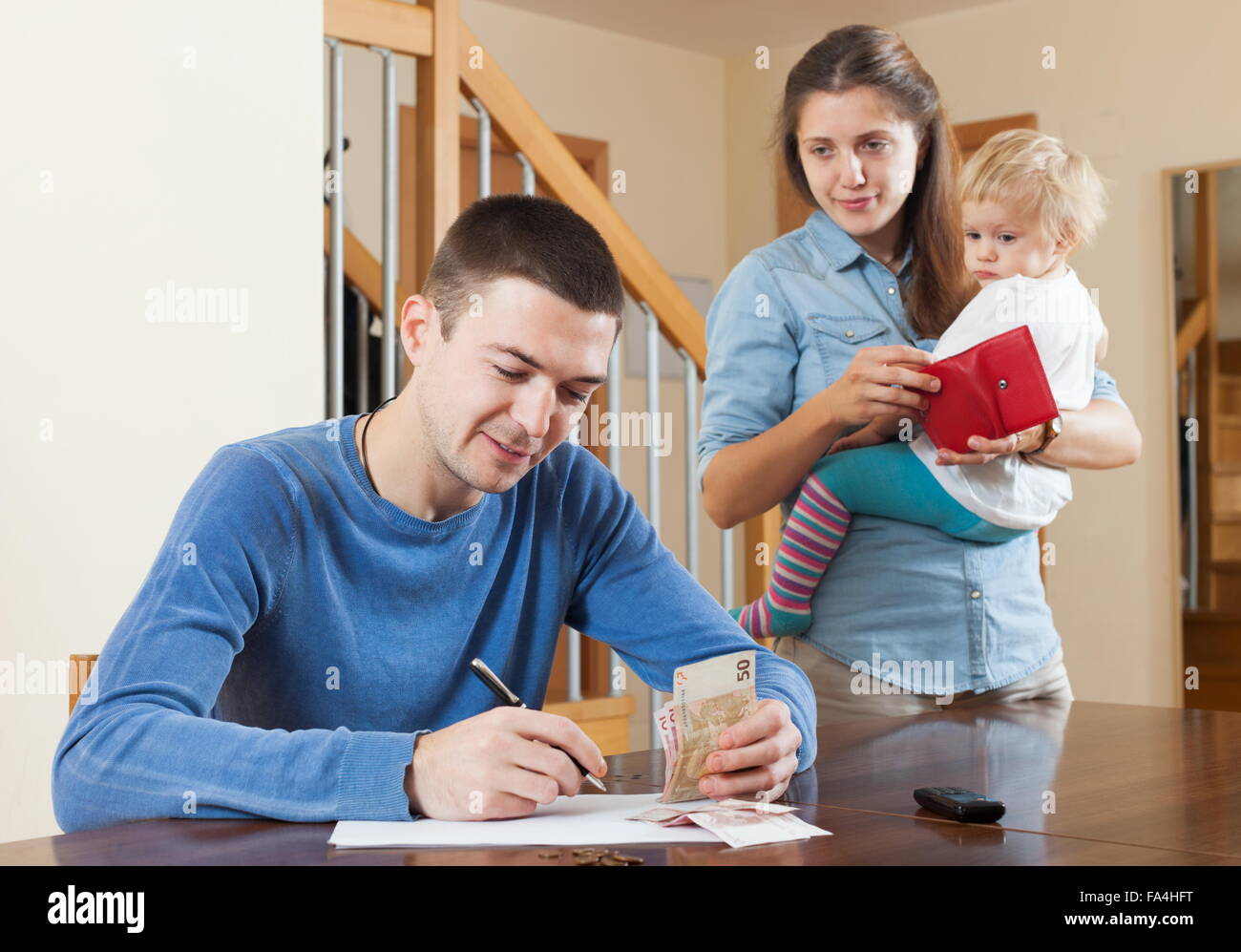 Quarrel in the family of three due to lack of money at home Stock Photo ...