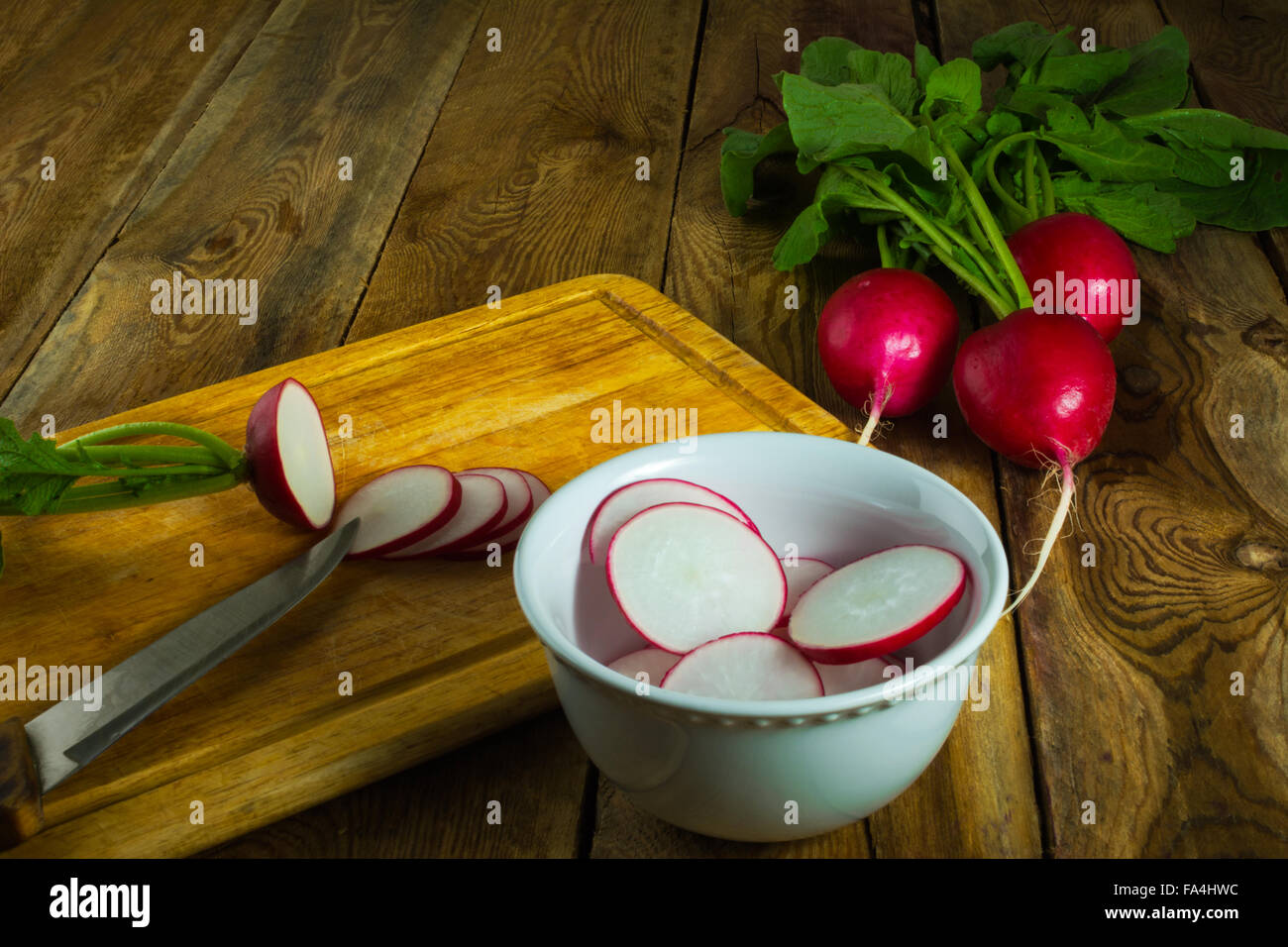 Slices of fresh radish on the used chopping board, copy space Stock ...