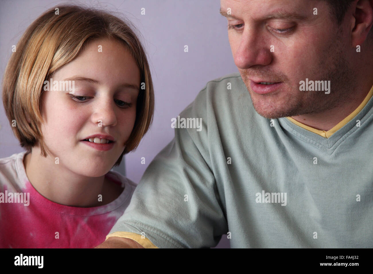 Single parent and young daughter working together Stock Photo - Alamy