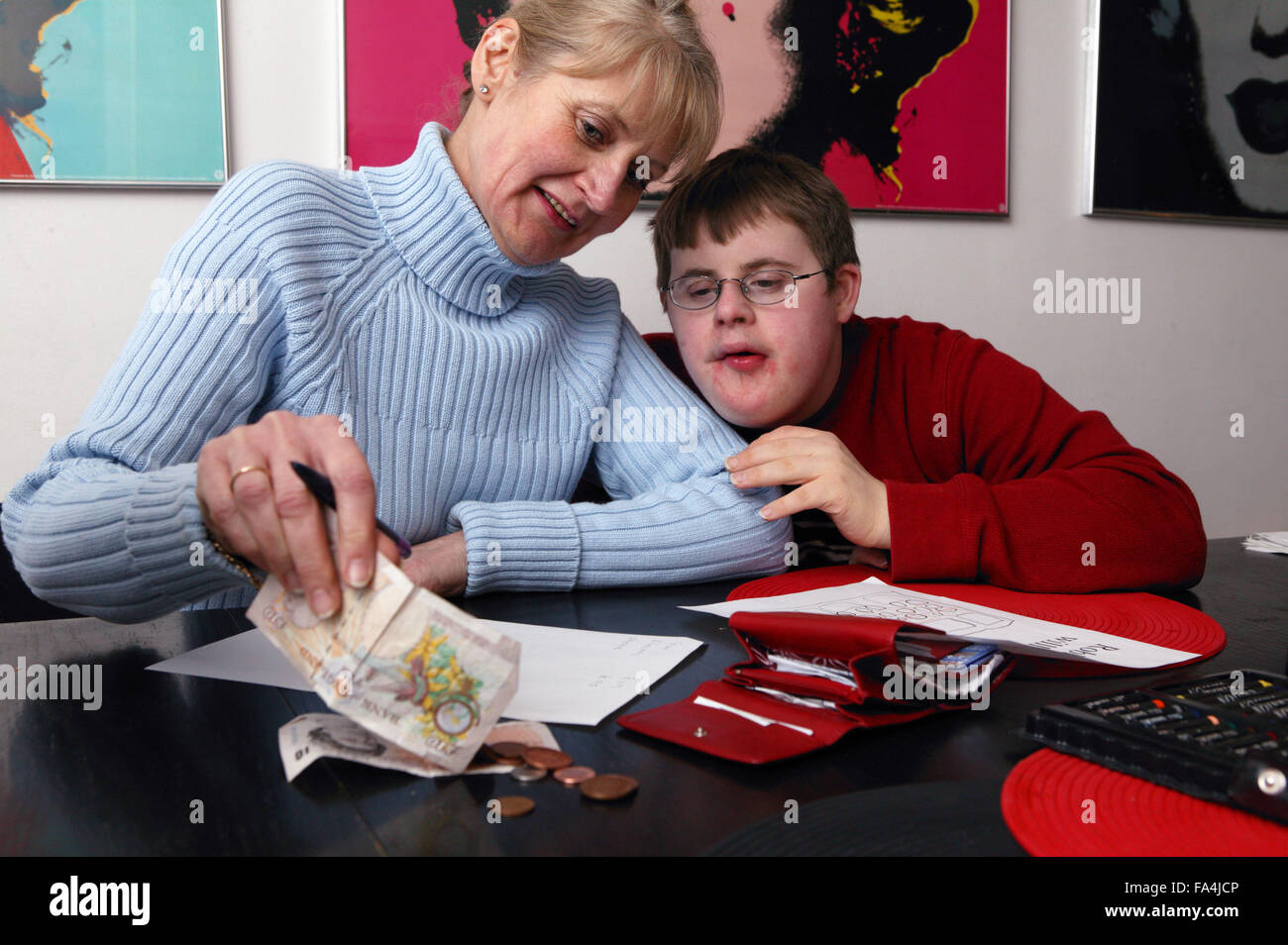 Single parent counting out money with her son Stock Photo - Alamy