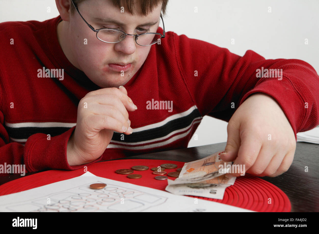 Boy counting out money Stock Photo - Alamy
