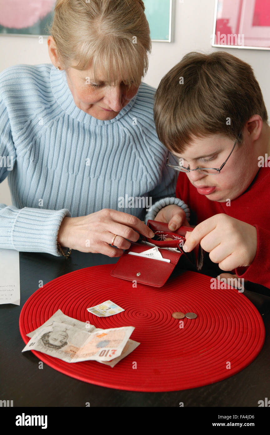 Single parent counting out money with her son Stock Photo - Alamy