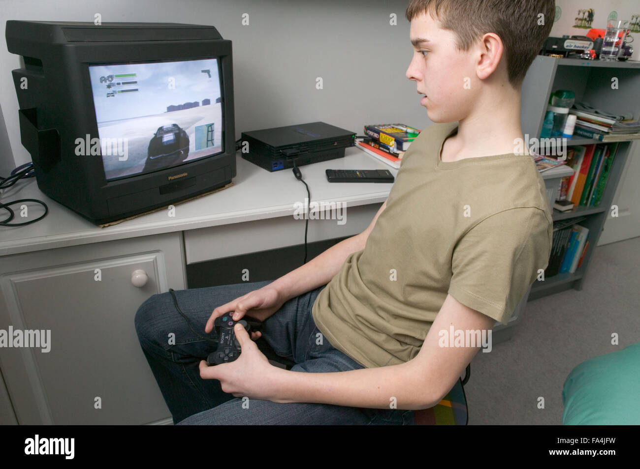 Boy playing a computer game in his bedroom Stock Photo - Alamy