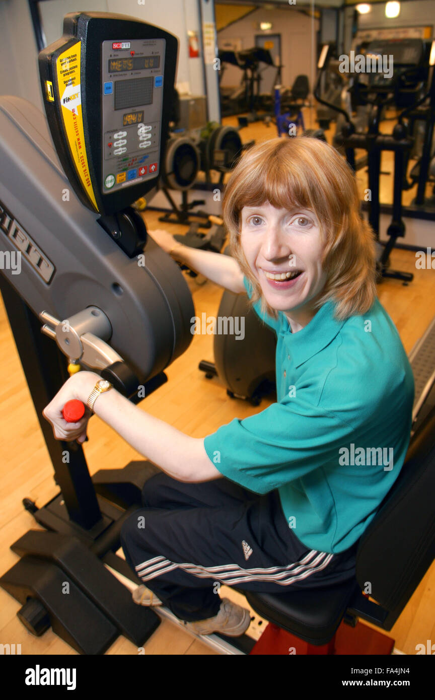Woman using upper body ergometer at an inclusive fitness gym Stock ...