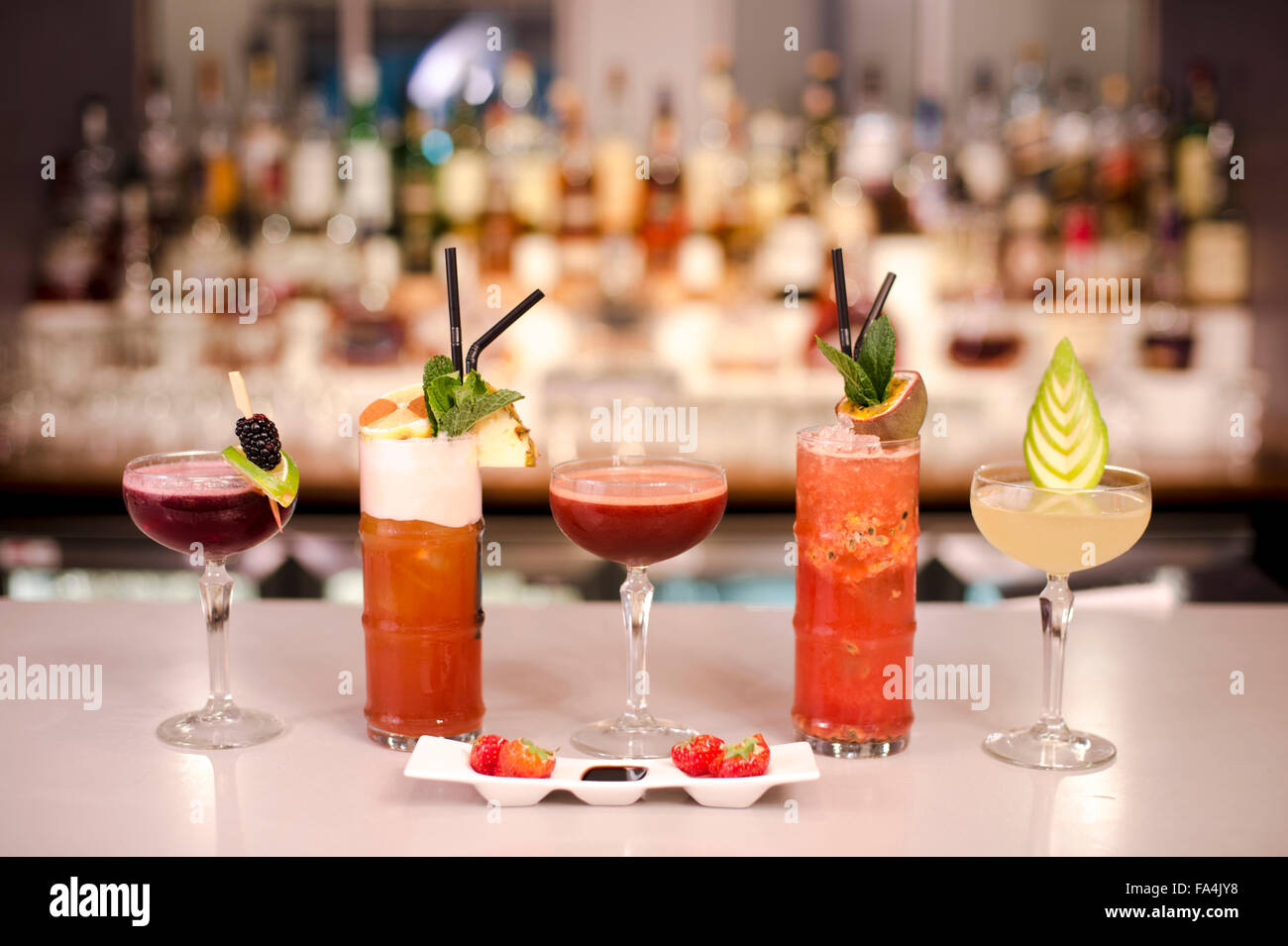 A range of cocktails displayed in front of a bar Stock Photo - Alamy