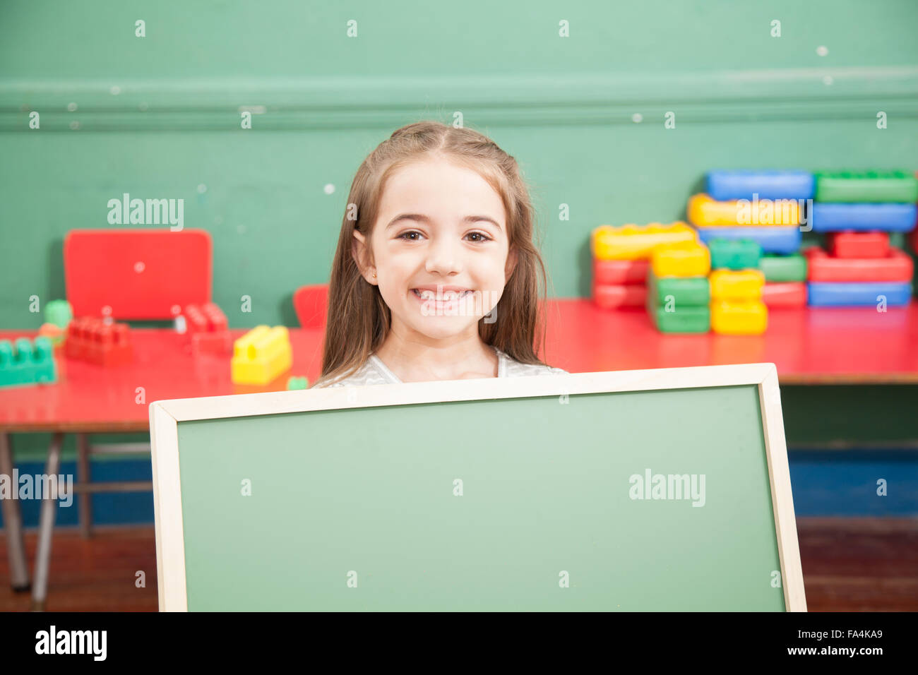 Girl showing a board Stock Photo - Alamy