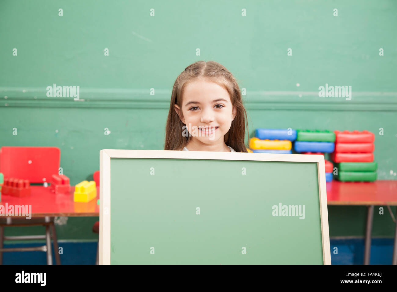 Girl showing a board Stock Photo - Alamy