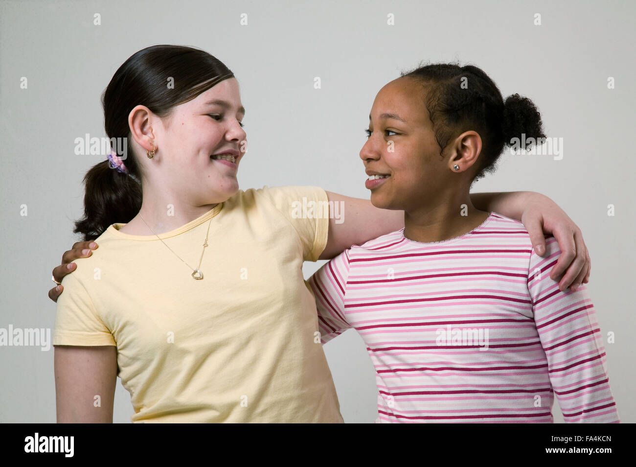 Two friends; looking at each other; laughing Stock Photo - Alamy