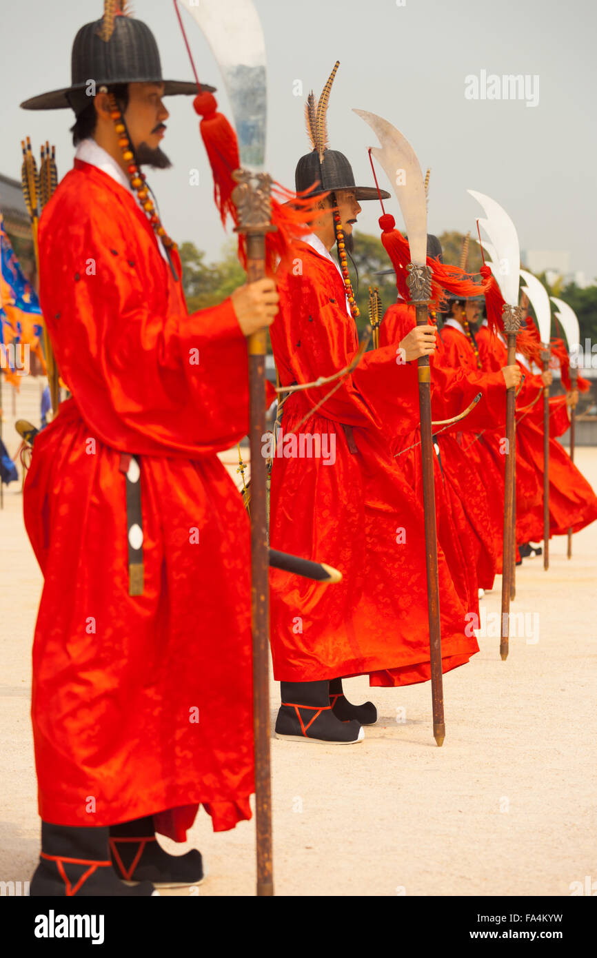 Row of armed guards in red ancient traditional period soldier uniforms ...