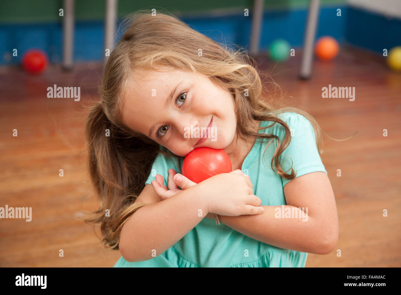 Child showing a red ball Stock Photo - Alamy