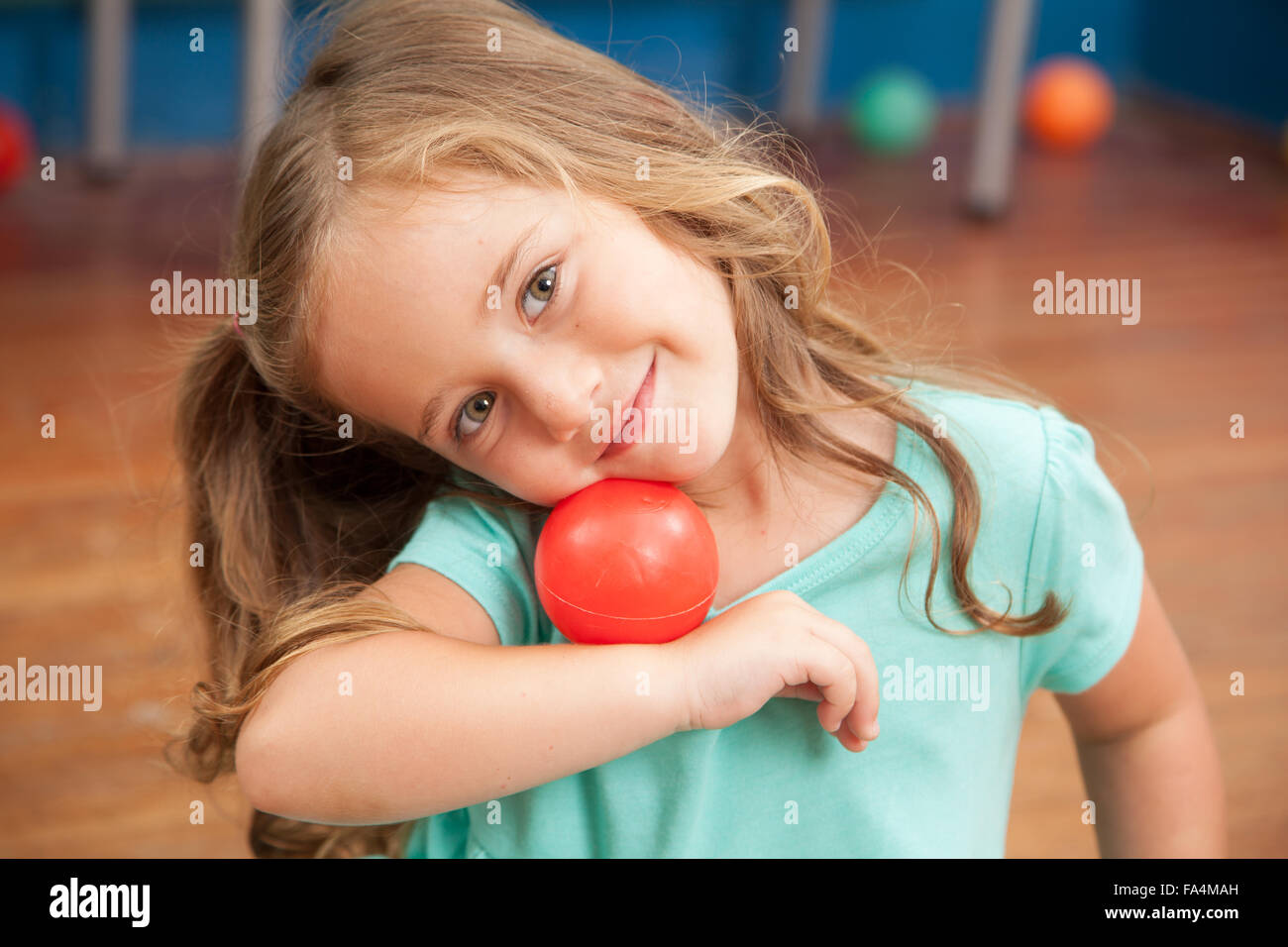 Child showing a red ball Stock Photo - Alamy