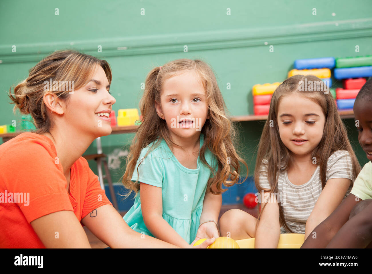 Teacher and pupils playing at school Stock Photo - Alamy