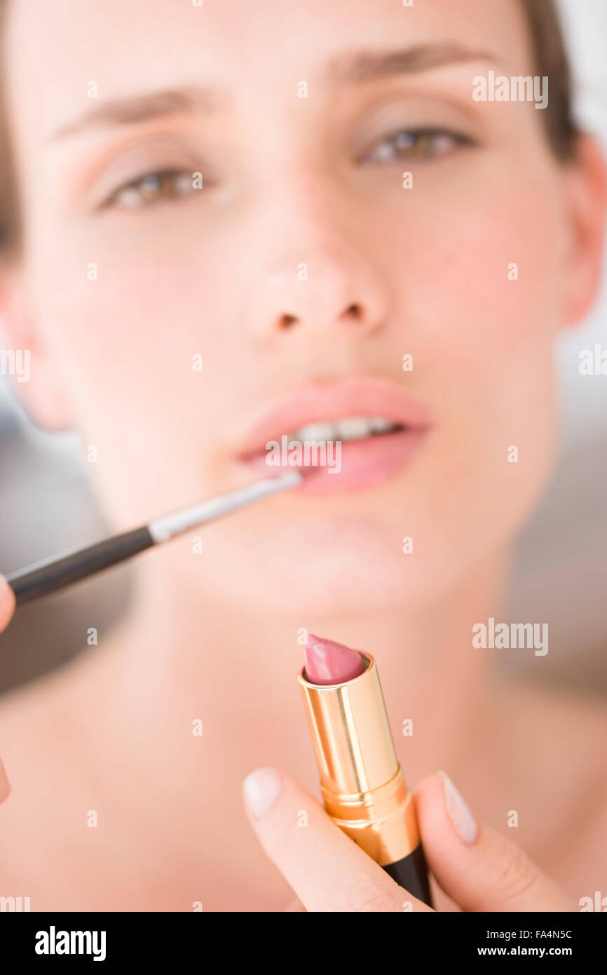 Beauty portrait of young woman applying makeup Stock Photo - Alamy