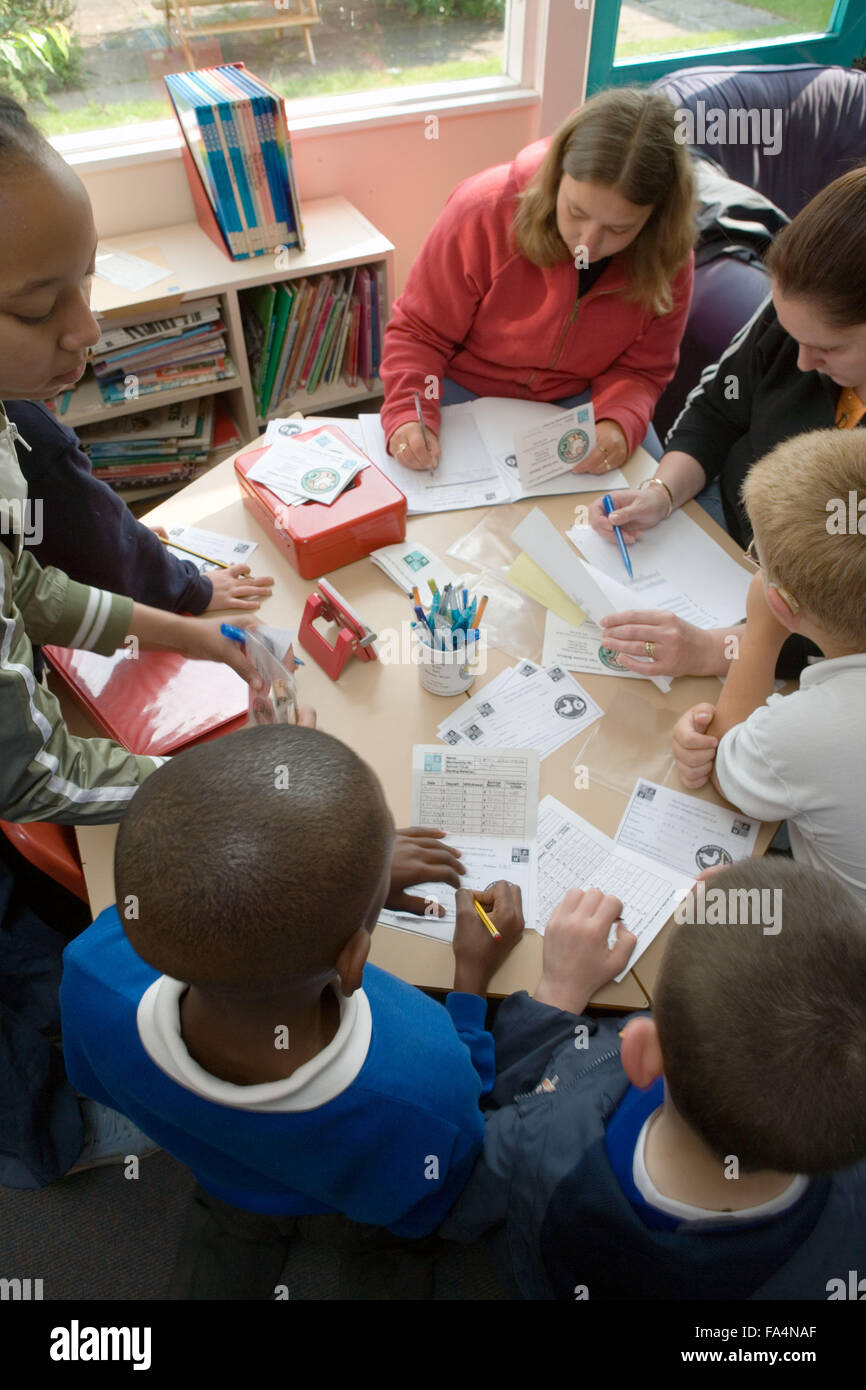 Group of children working on school project in classroom Stock Photo ...