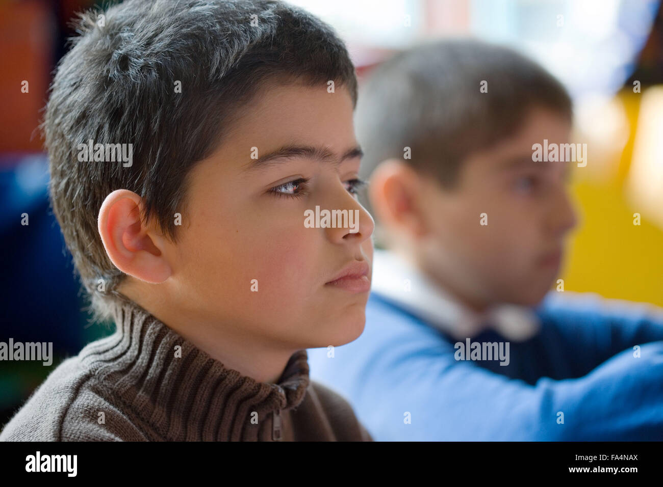 Portrait of boy looking serious during school assembly Stock Photo - Alamy