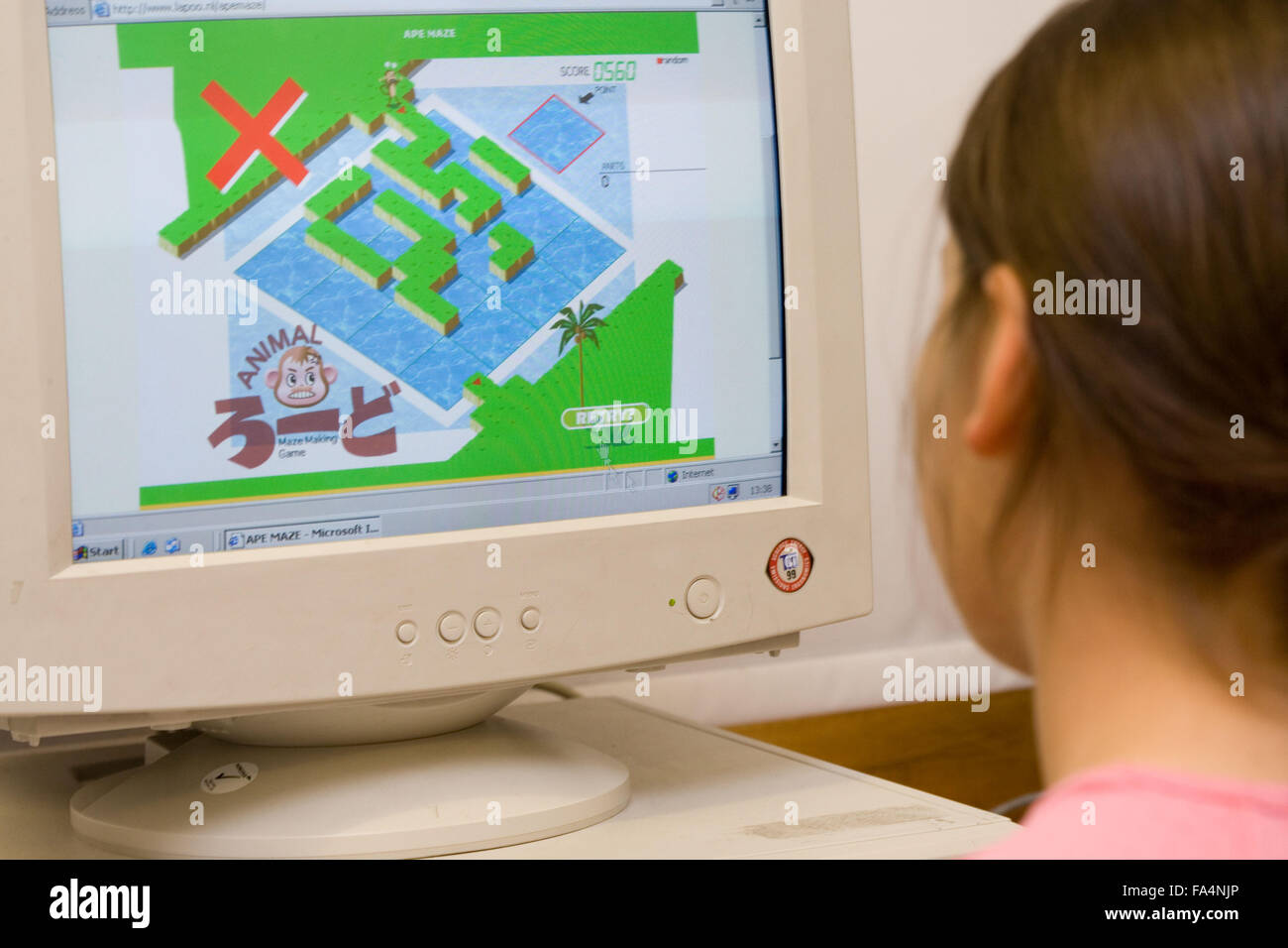 Girl sitting at desk using computer Stock Photo - Alamy