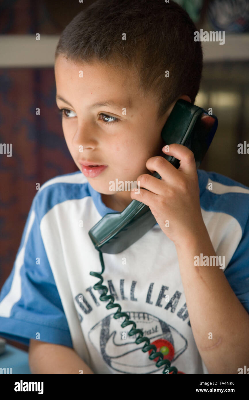 Boy using telephone Stock Photo - Alamy