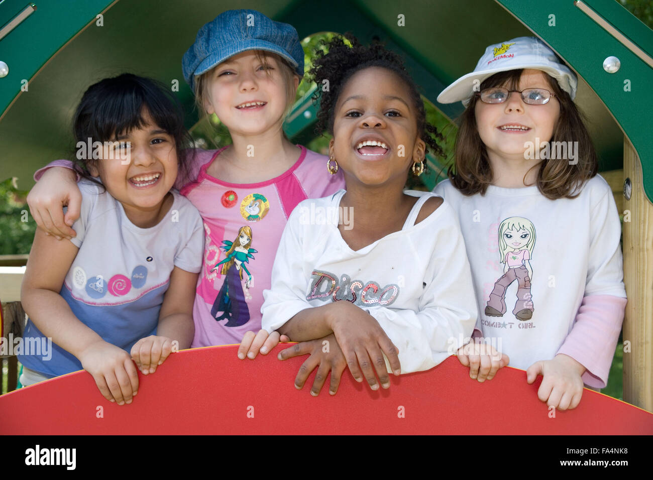 Group of children standing together on climbing frame smiling Stock ...