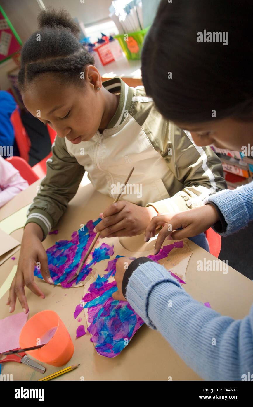 Two girls working on school project during art lesson Stock Photo - Alamy