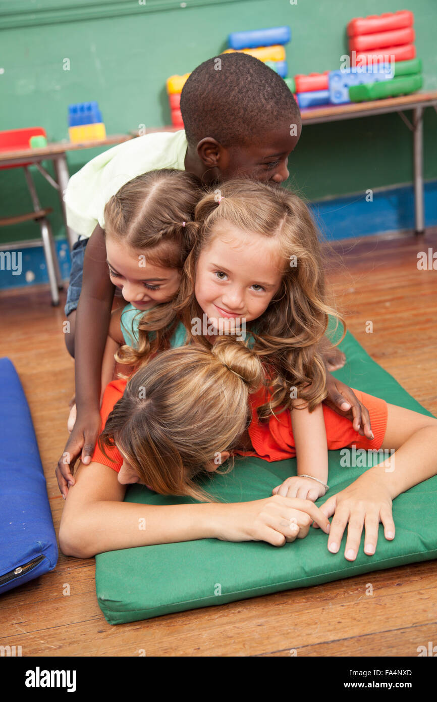 Teacher and pupils playing at school Stock Photo - Alamy