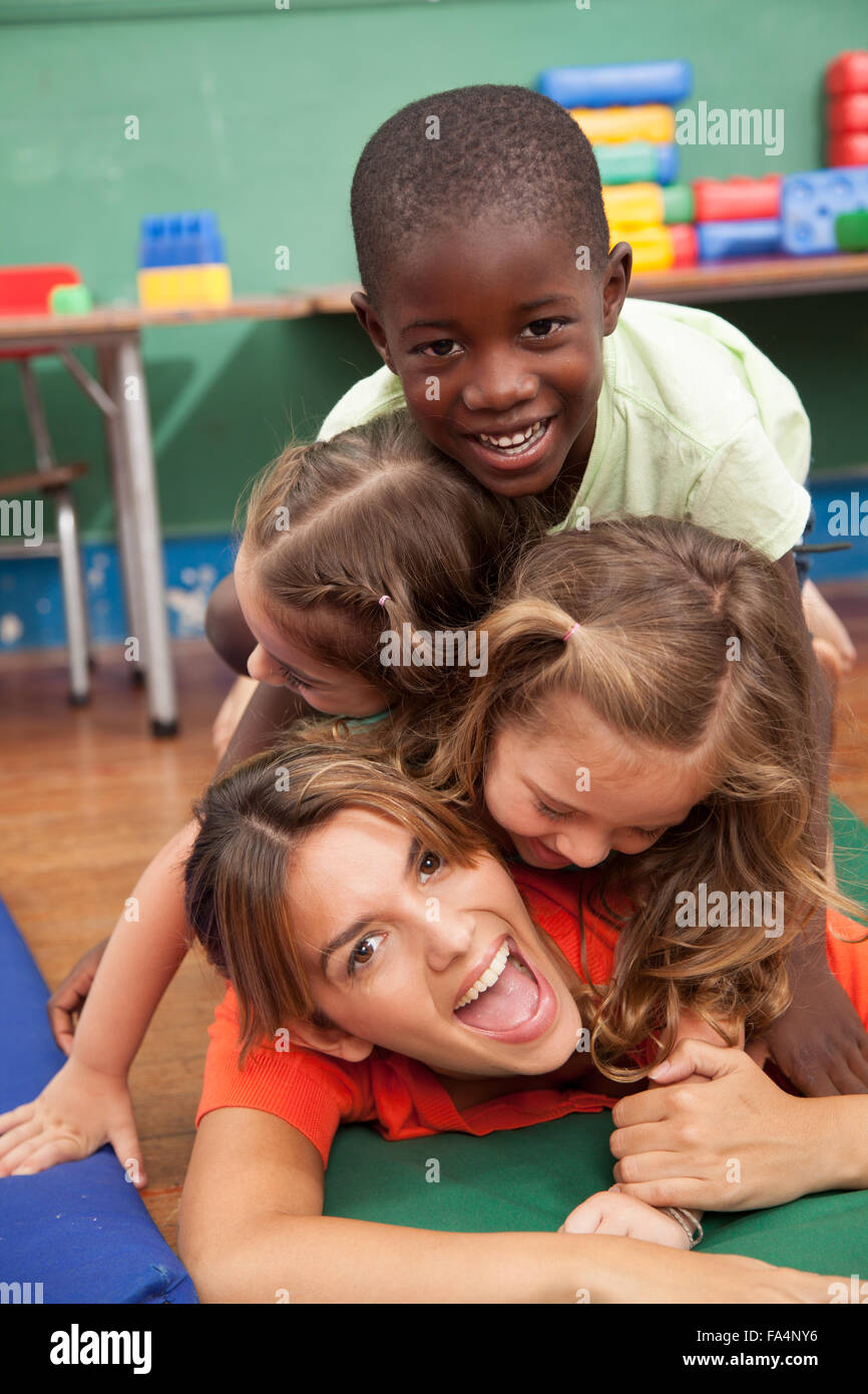 Teacher and pupils playing at school Stock Photo - Alamy