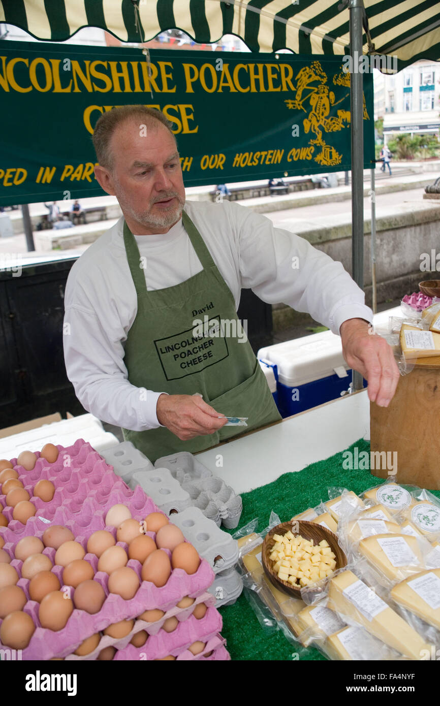 Stallholder serving fresh local produce on a Lincolnshire Poacher ...