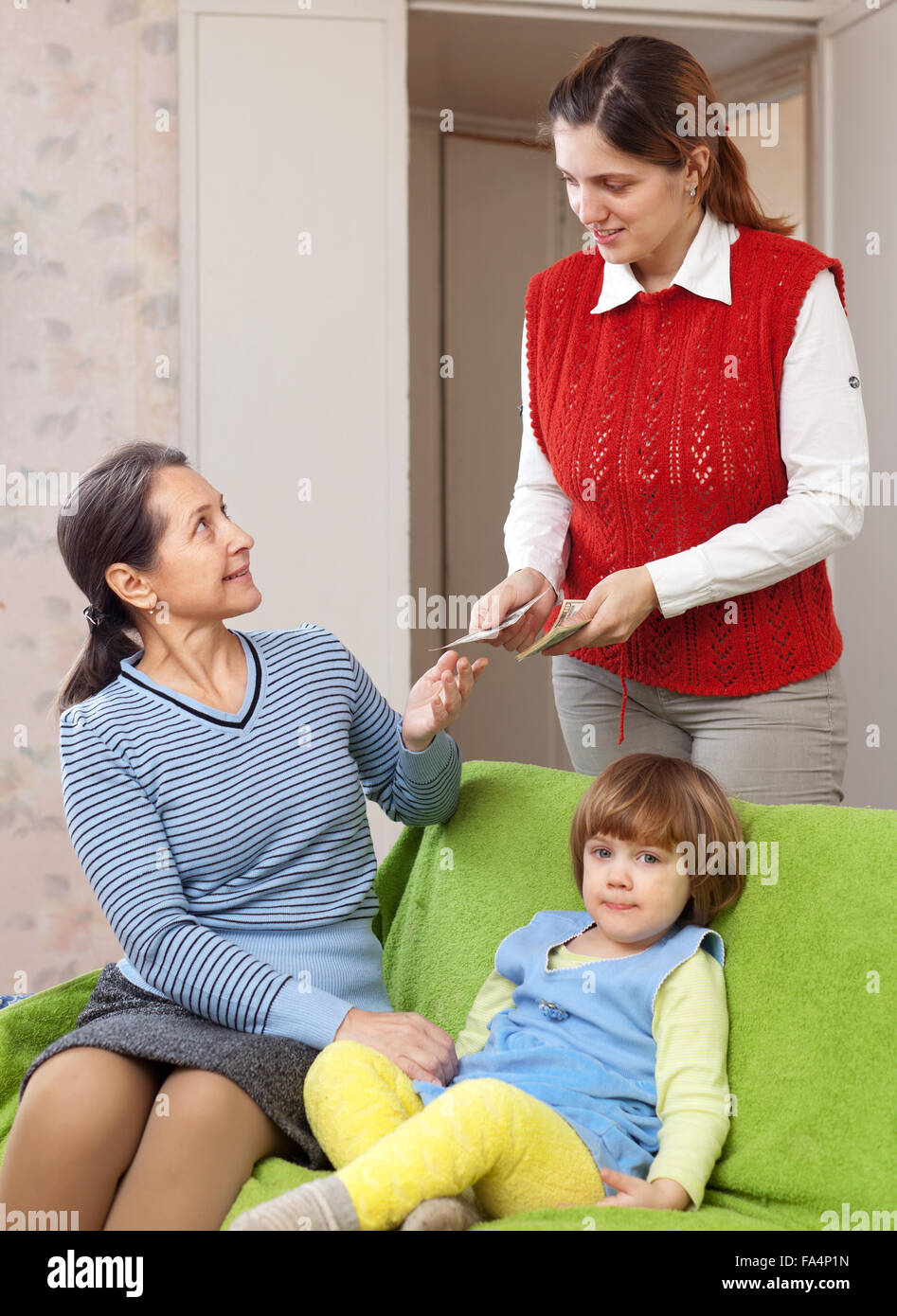 Mother hires nanny for her child at home Stock Photo - Alamy