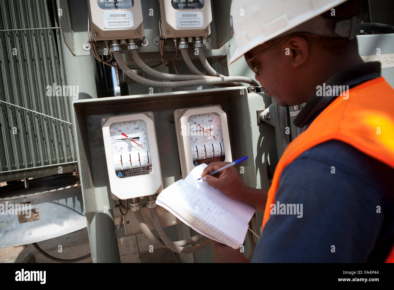An electrical engineer maintains equipment at Mtoni Service Station in ...