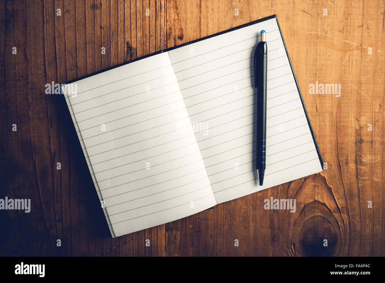 Top view of open notebook with blank pages and pencil on old wooden ...