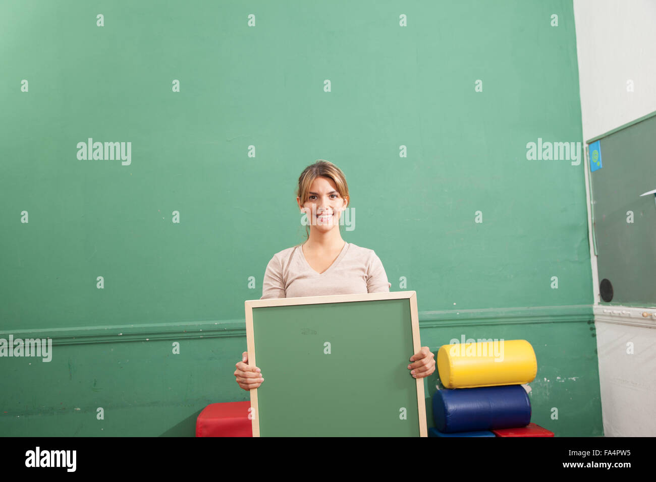 Teacher showing the board Stock Photo - Alamy