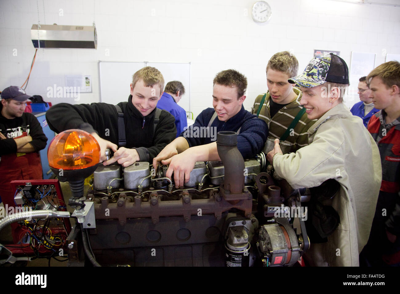 Practical education at a tractor. Master explains the engine of an ...