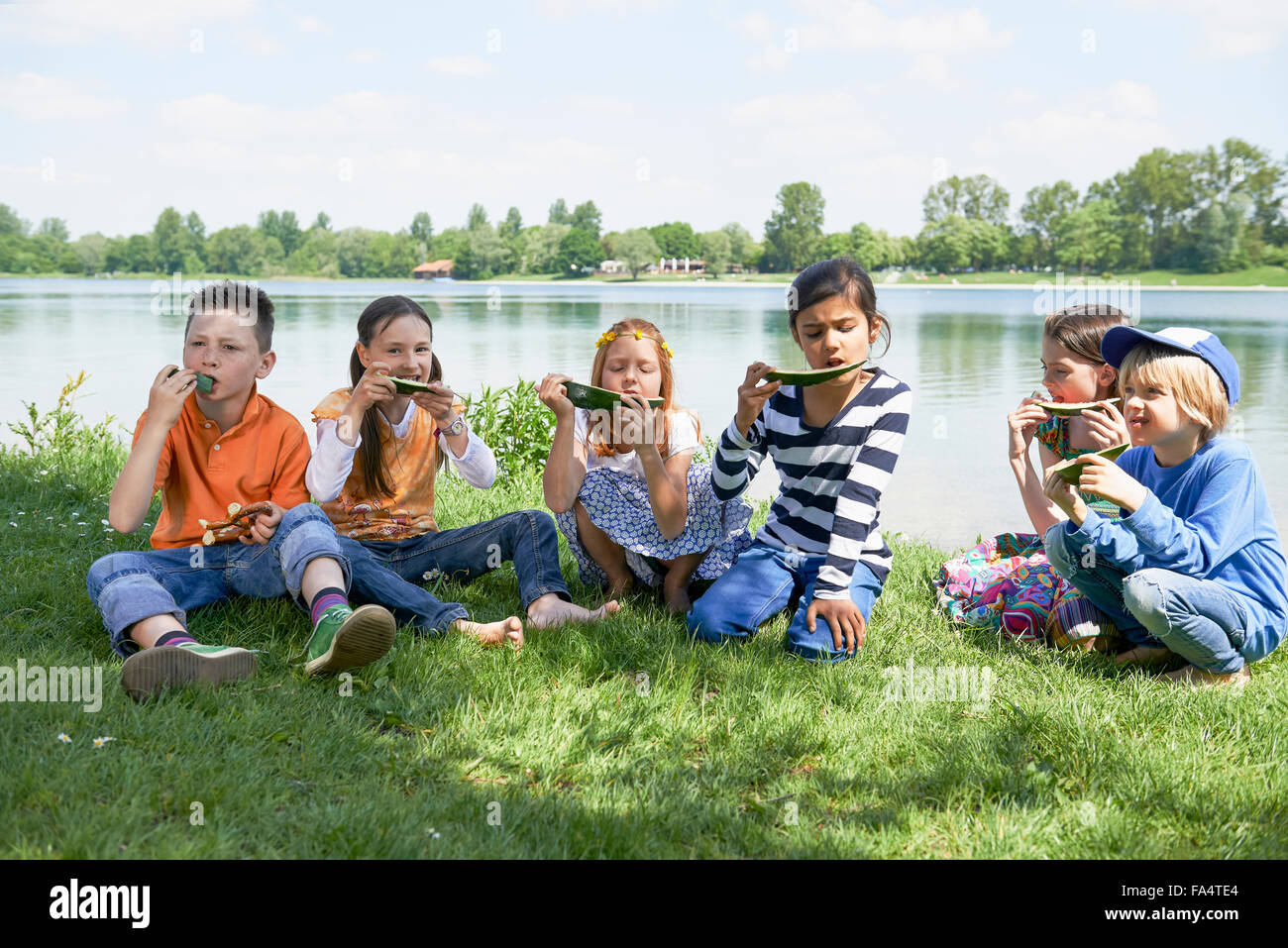 Children enjoying slices of watermelon at picnic, Munich, Bavaria ...
