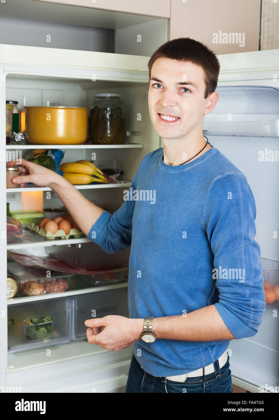 Handsome guy near opened refrigerator in kitchen at home Stock Photo ...