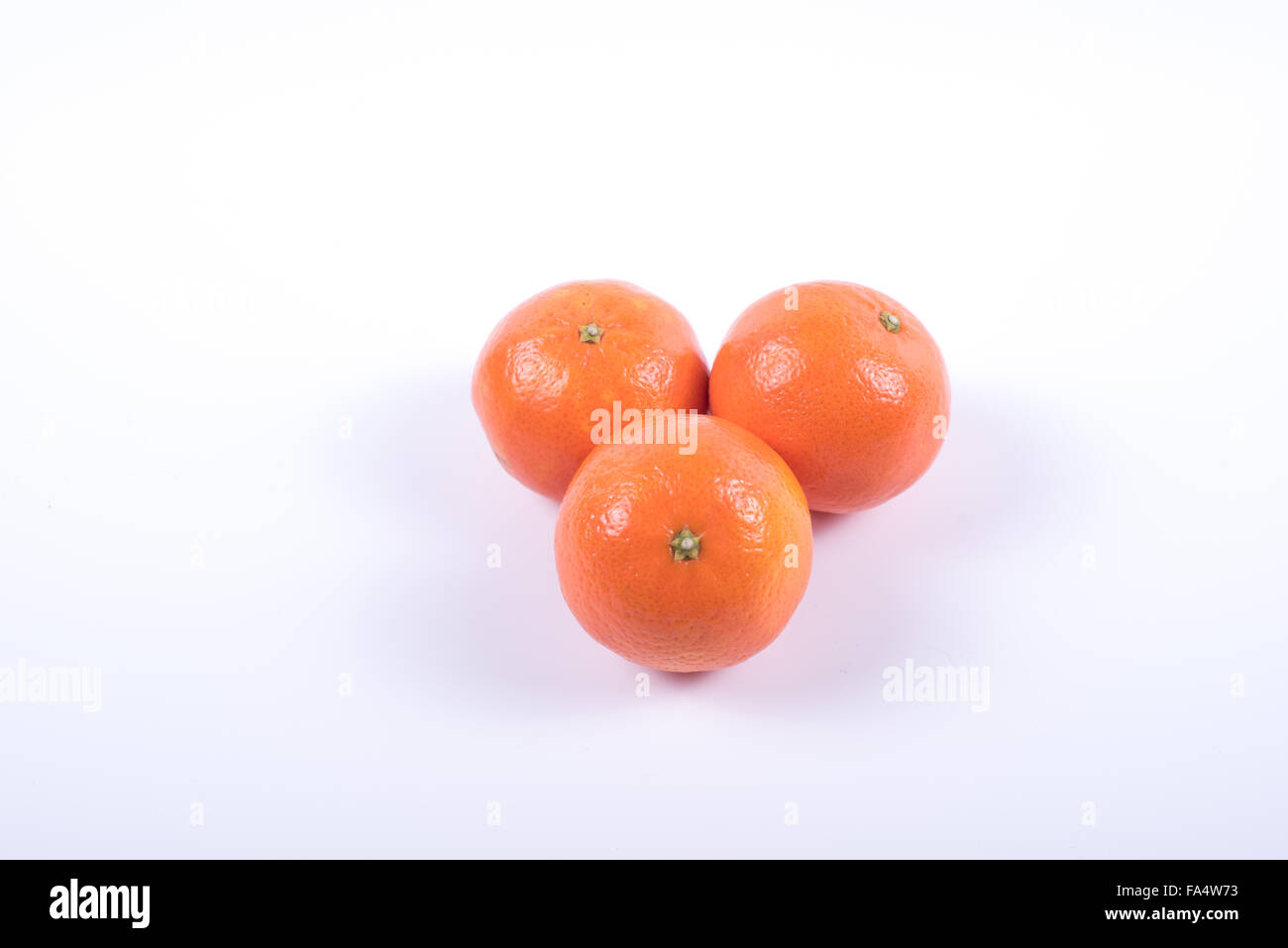 close up of three tangerines isolated on white background Stock Photo ...