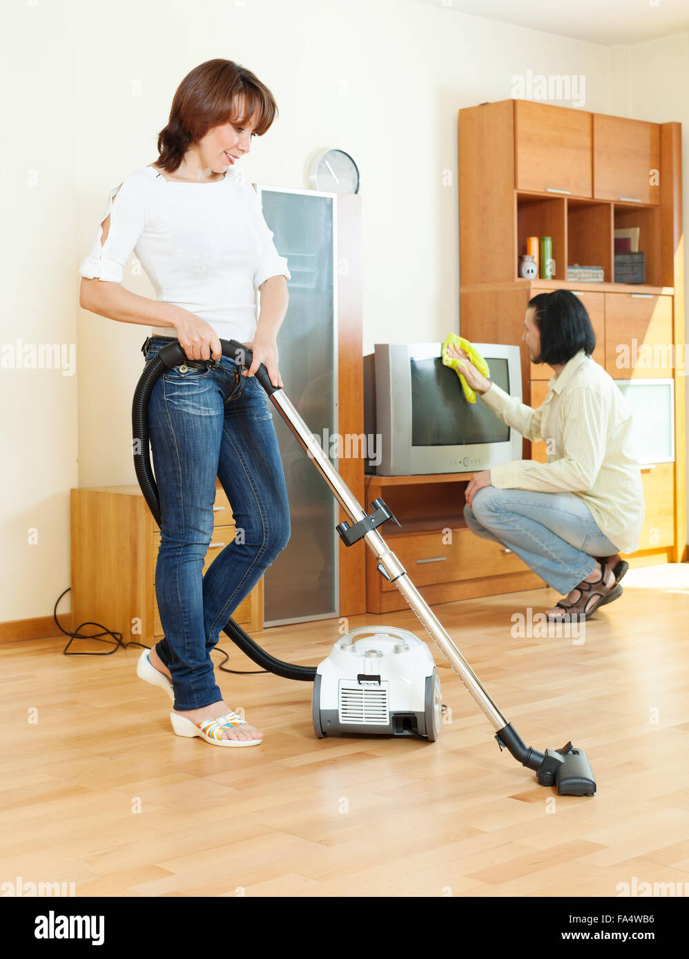 amicable couple doing housework together in home Stock Photo - Alamy