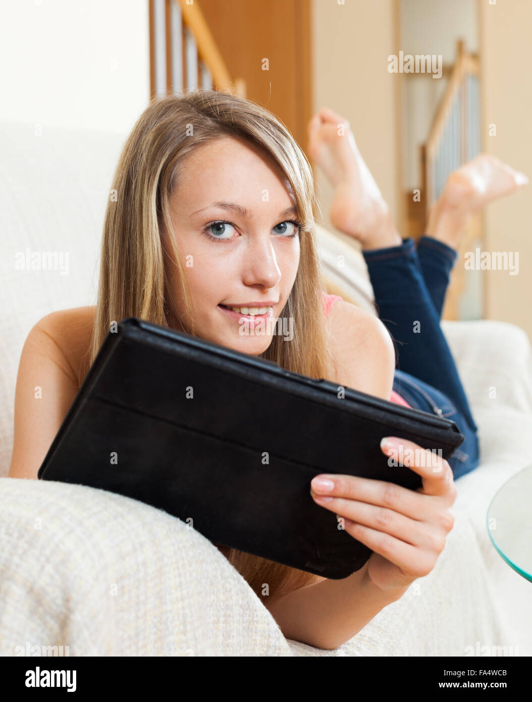 Charming girl browsing web with tablet at her rest-day Stock Photo - Alamy