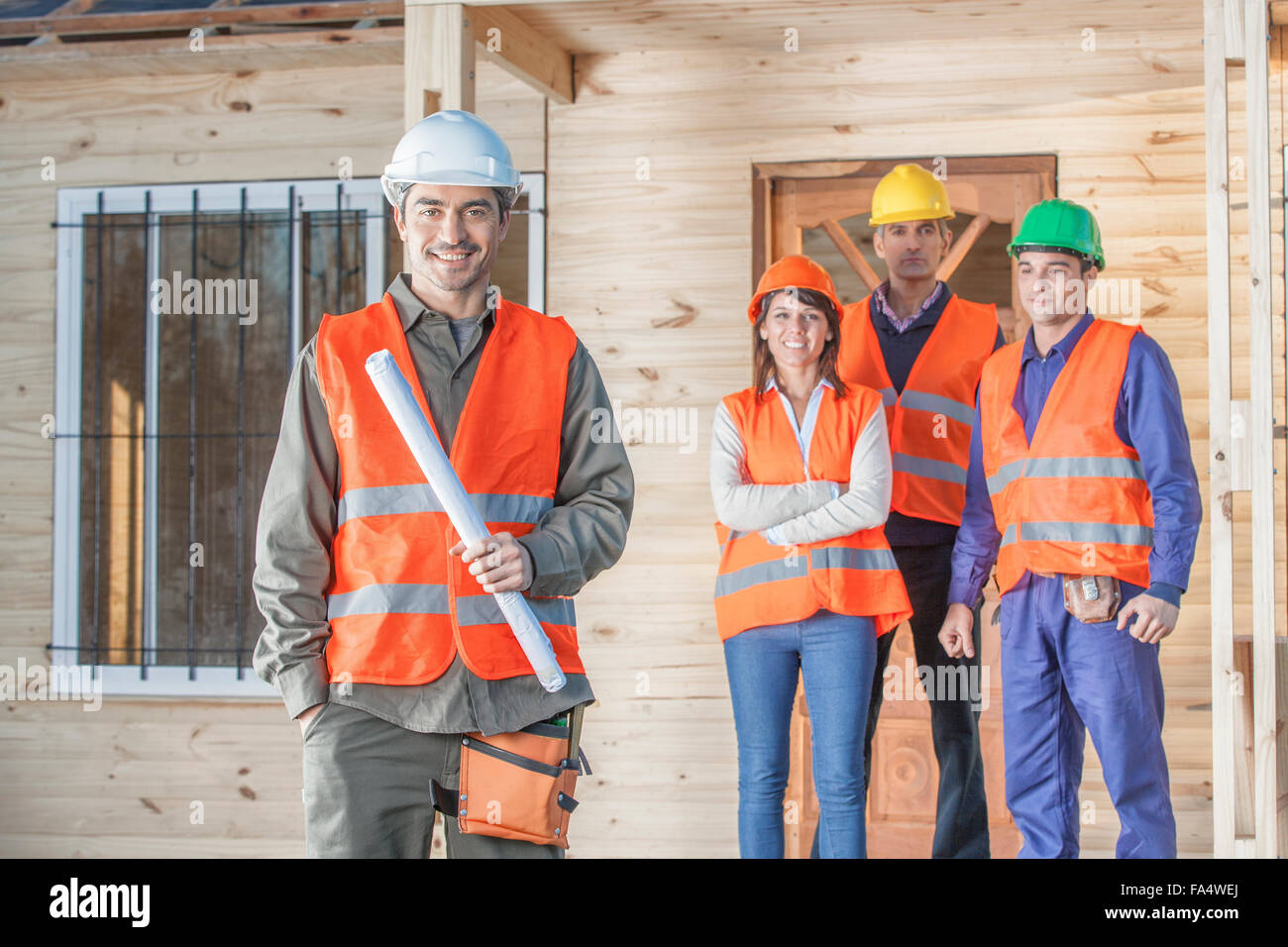 4 person construction crew at the construction site Stock Photo - Alamy