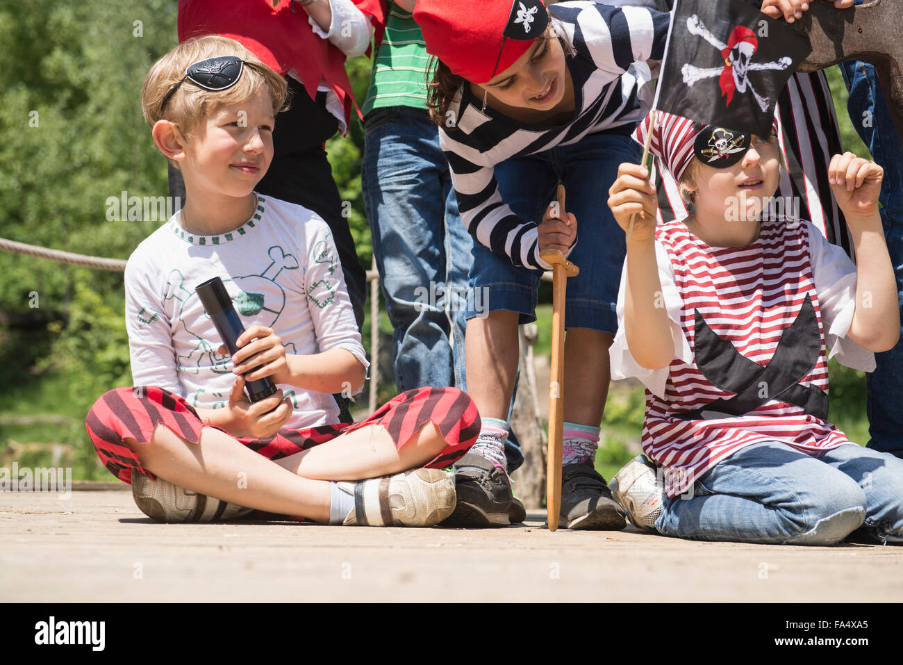 Group of children playing on a pirate ship in adventure playground ...